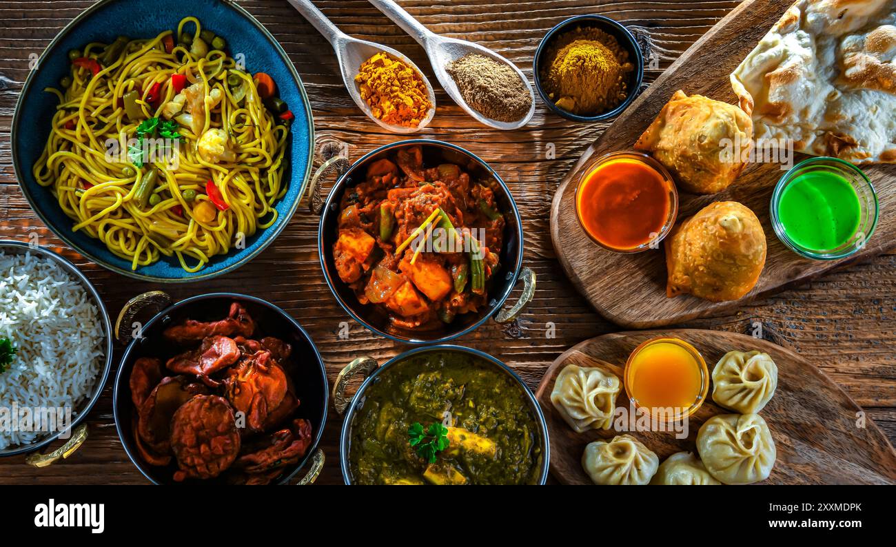 Composition with indian dishes: samosa, pakora, palak paneer, jalfrezi ...