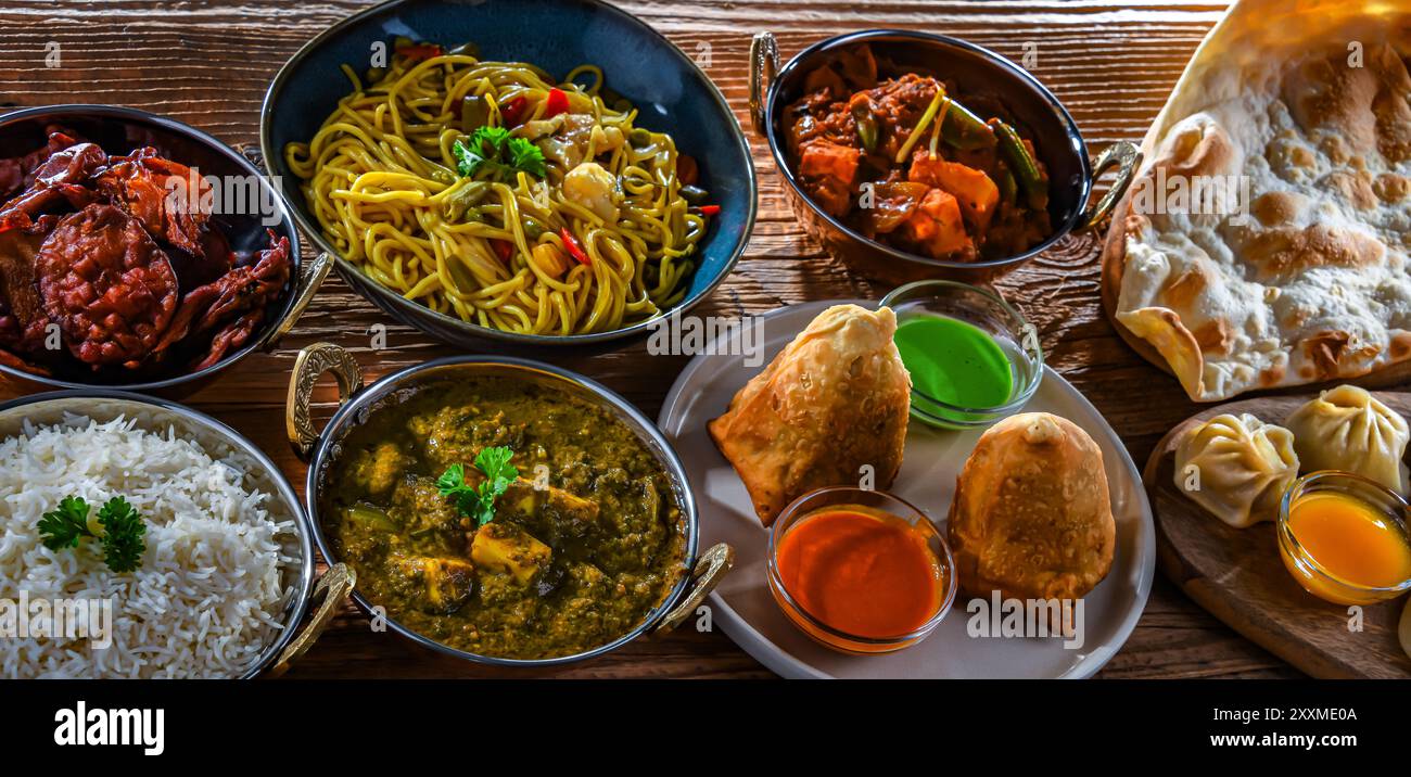 Composition with indian dishes: samosa, pakora, palak paneer, jalfrezi ...