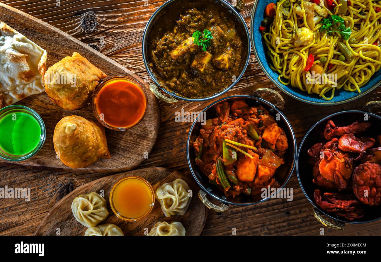 Composition with indian dishes: samosa, pakora, palak paneer, jalfrezi ...