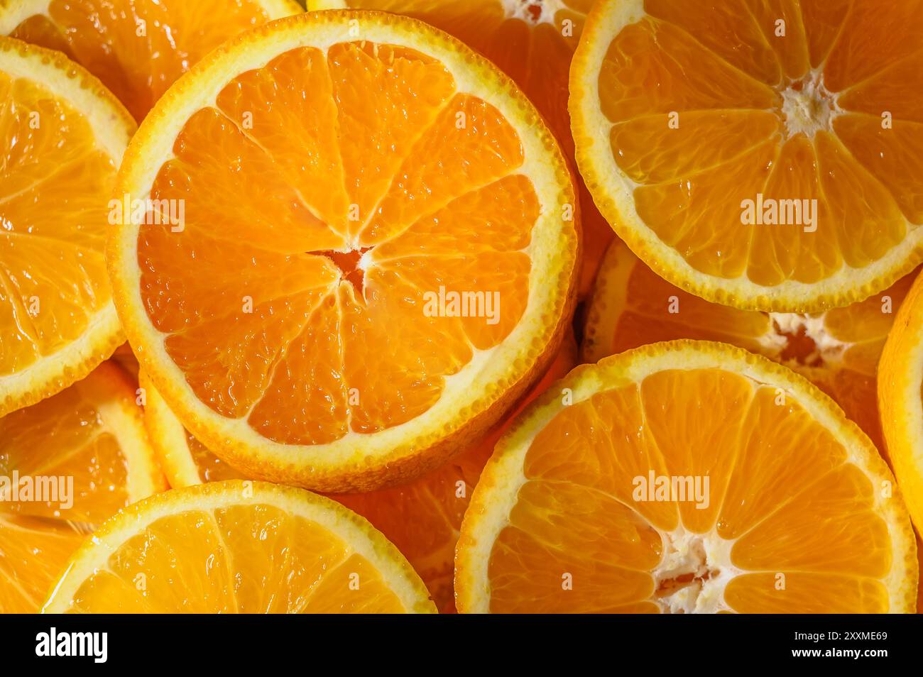 Colorful slices of fresh oranges as background with sun rays Stock ...