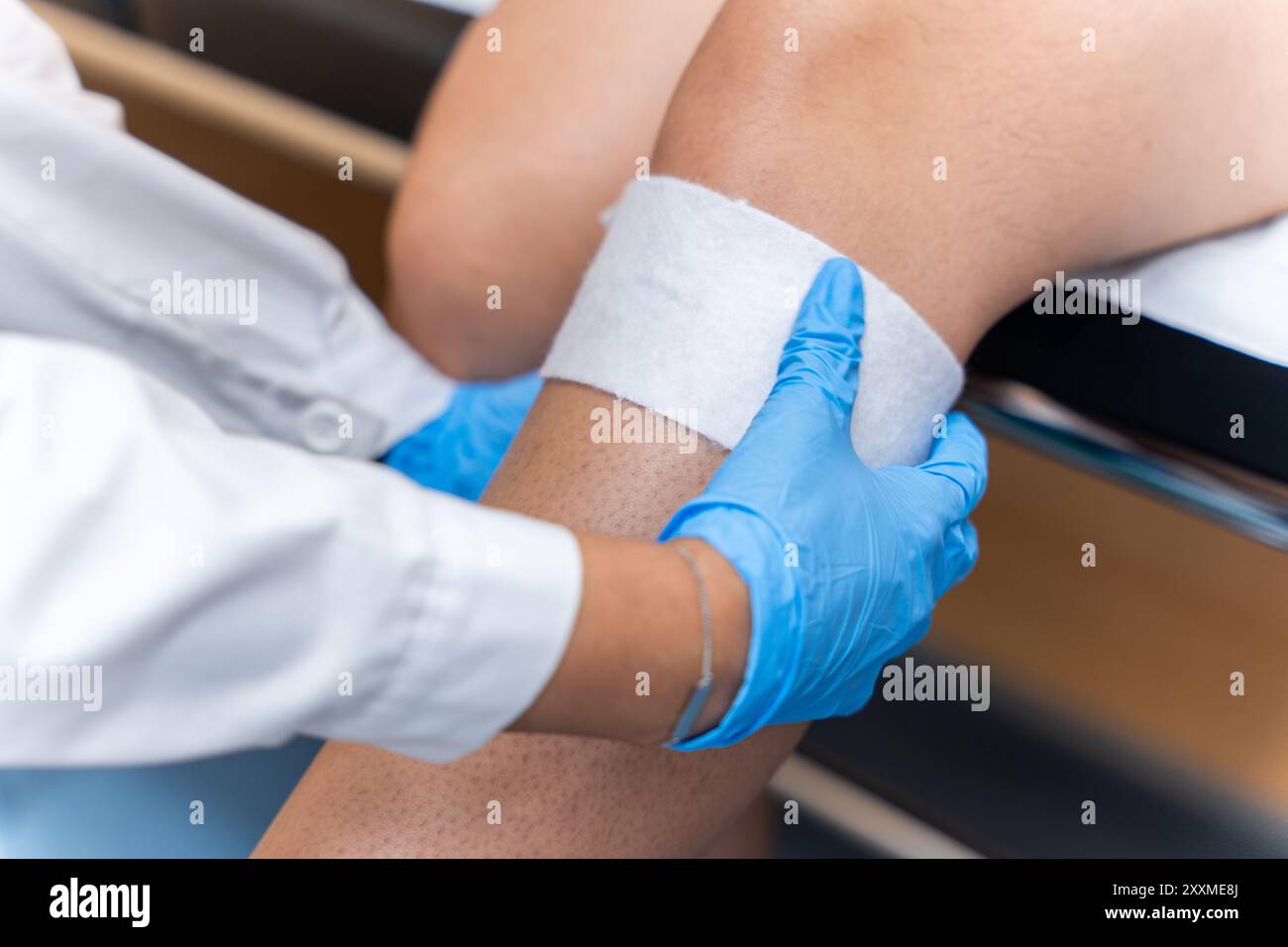 Hands of a doctor putting a bandage on a patient Stock Photo - Alamy