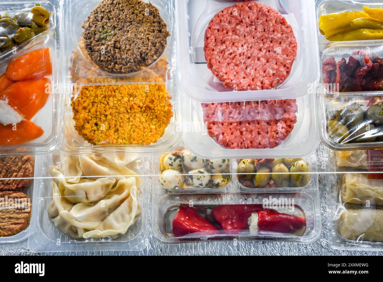 A display of variety of prepackaged food products in plastic boxes ...