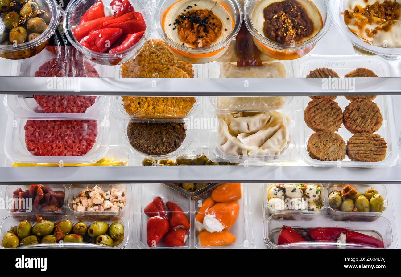 A display of variety of prepackaged food products in plastic boxes ...