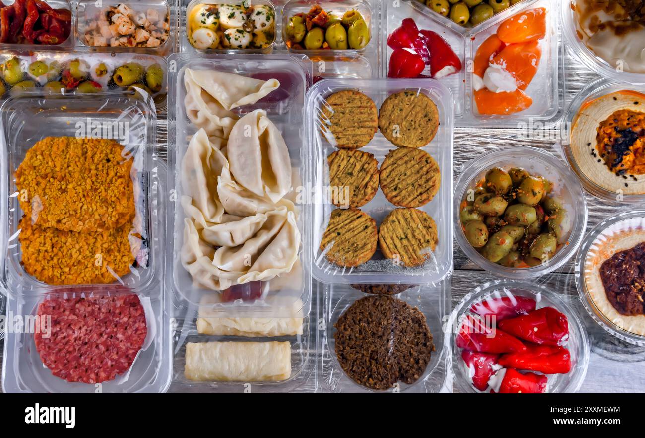 A display of variety of prepackaged food products in plastic boxes ...