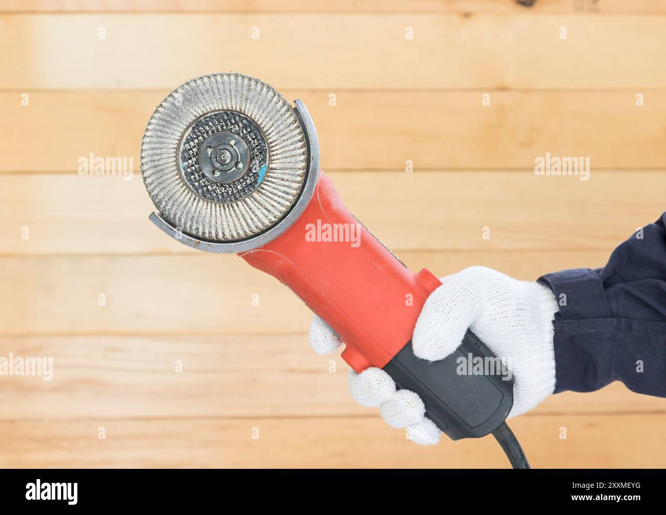 Hand in glove holding Circular saw with an abrasive disk for wood ...