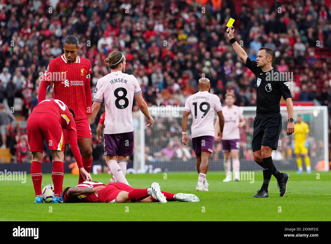 Brentford's Mathias Jensen (centre left) is shown a yellow card by ...