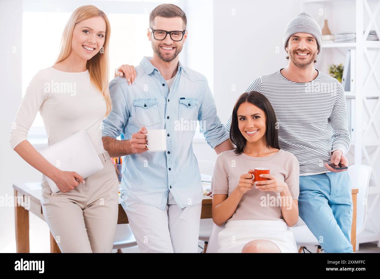 Successful creative team. Group of business people in smart casual wear looking at camera and ...