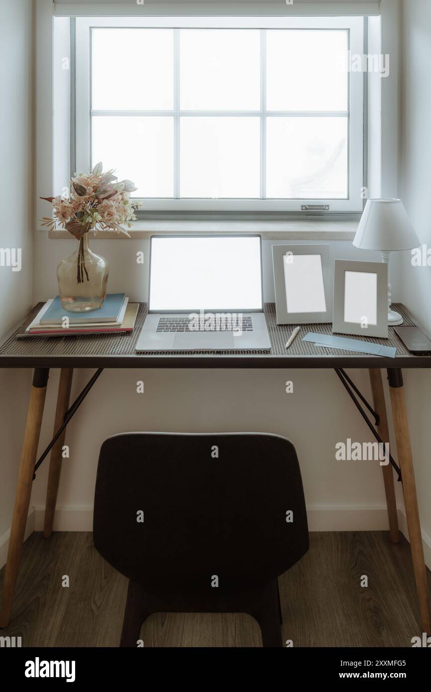 A minimalistic home office setup featuring a laptop with its blank ...