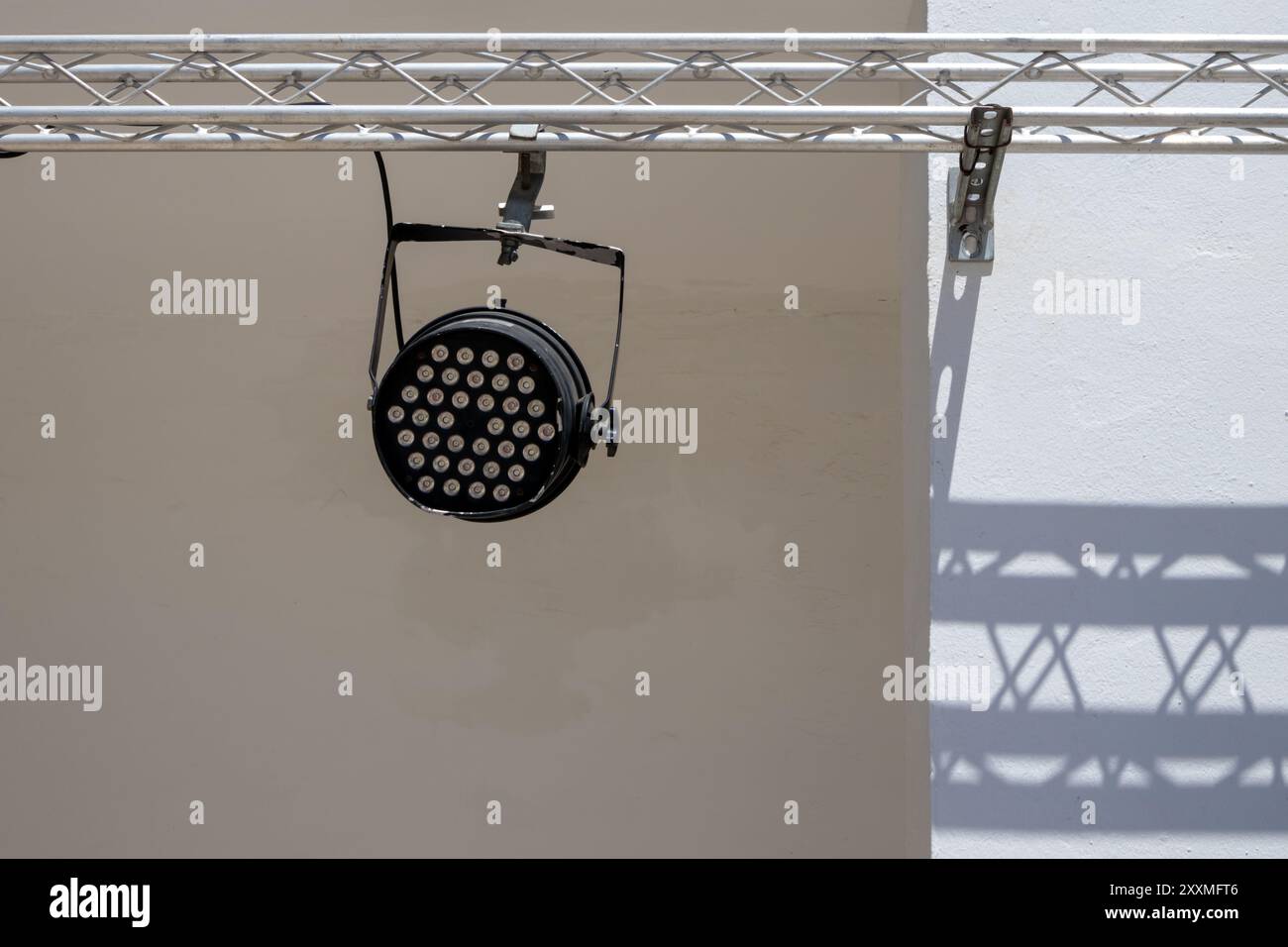 Party light on a ramp outdoor. Wall in the background with a structured ...