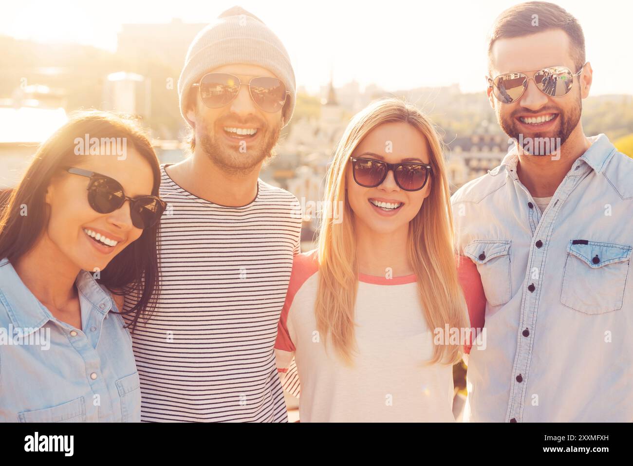 The best friends ever. Four young cheerful people bonding to each other ...