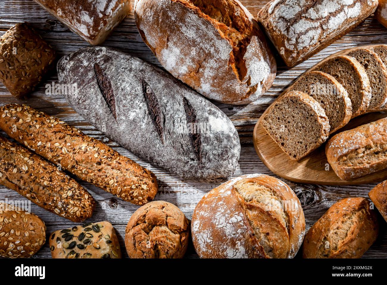 Assorted bakery products including loaves of bread and rolls Stock ...