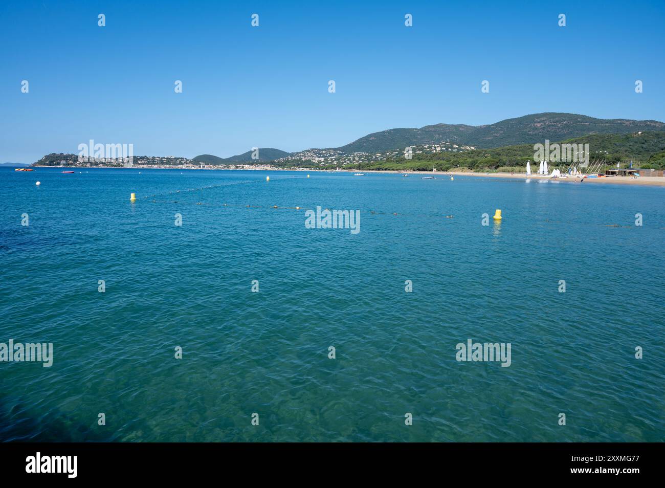Morning view on crystal clear blue water and pier of Plage du ...