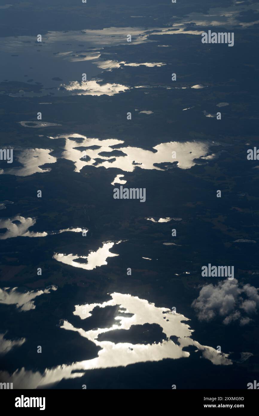 aerial view of fluffy white clouds casting shadows on the landscape ...