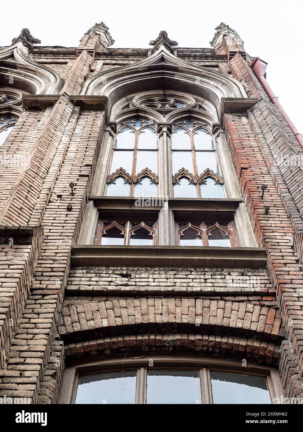 window in old school building in gothic style in Tbilisi city on summer ...