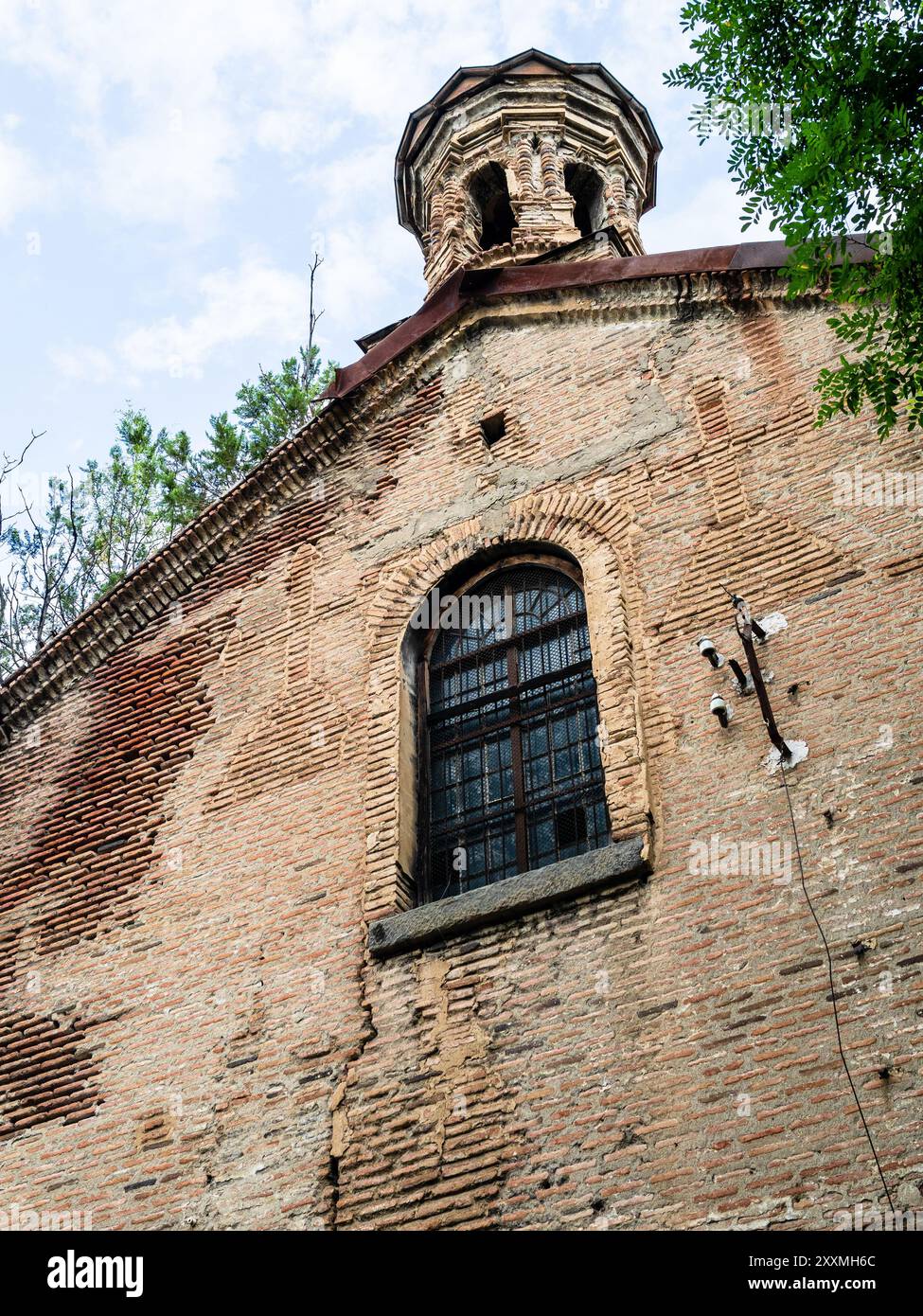 wall of old Saint George of Mughni Church in Tbilisi city on summer day ...