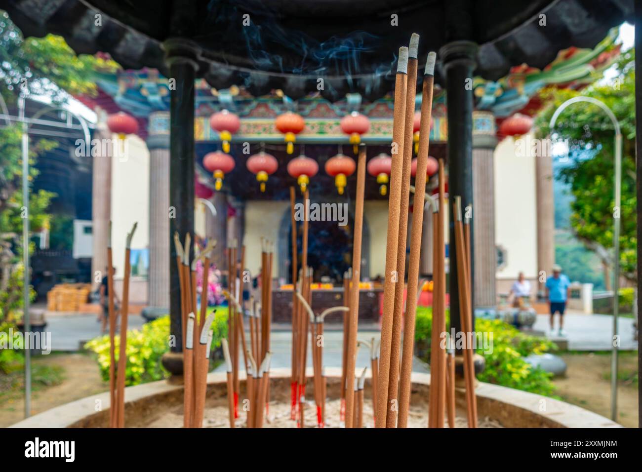 Joss sticks burn in an censer to add flagrance to the air outside one ...