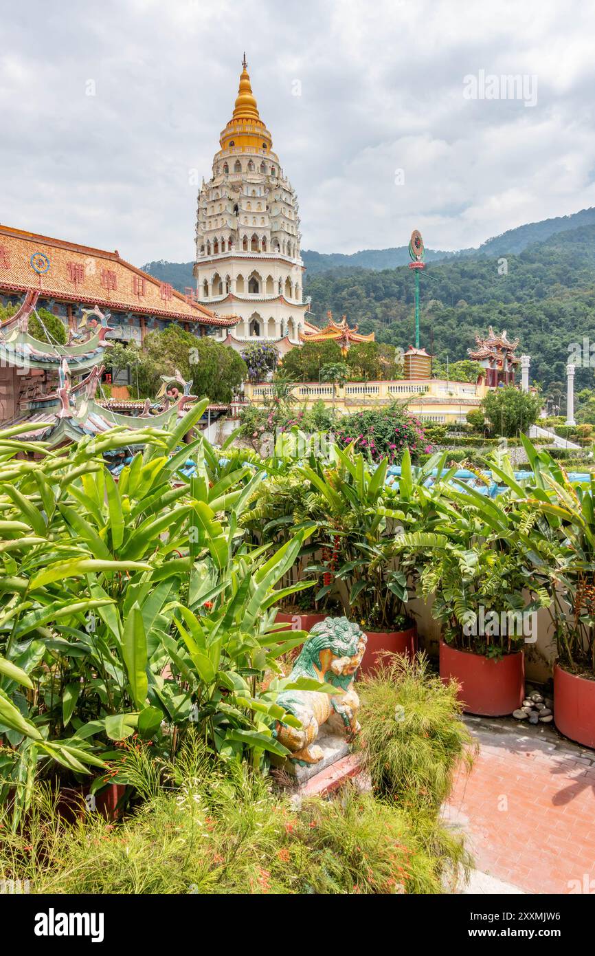 The Ten Thousand Buddhas Pagoda stands in front of a forested hillside ...