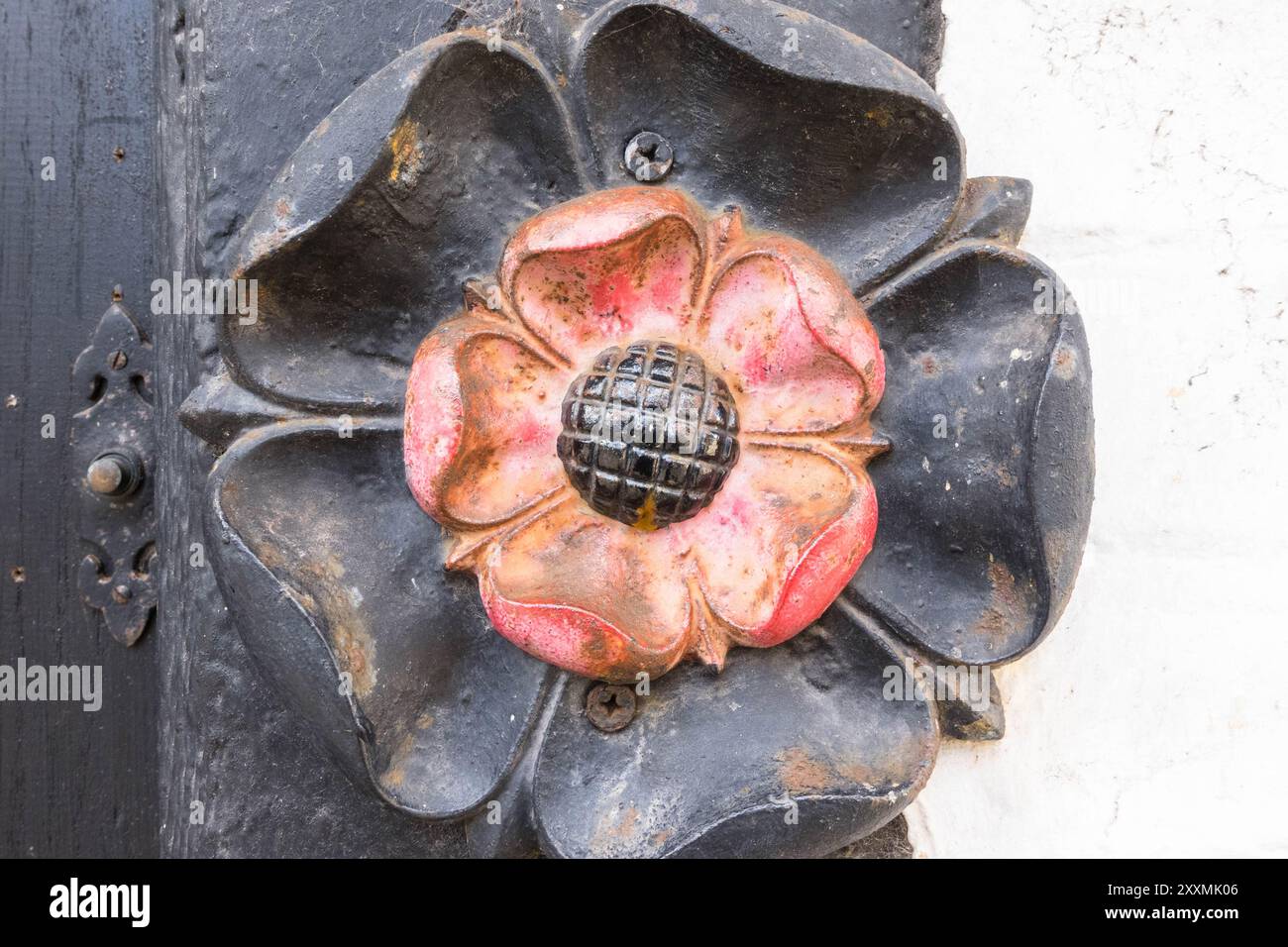 Tudor Rose emblem on the entrance to a black and white property ...