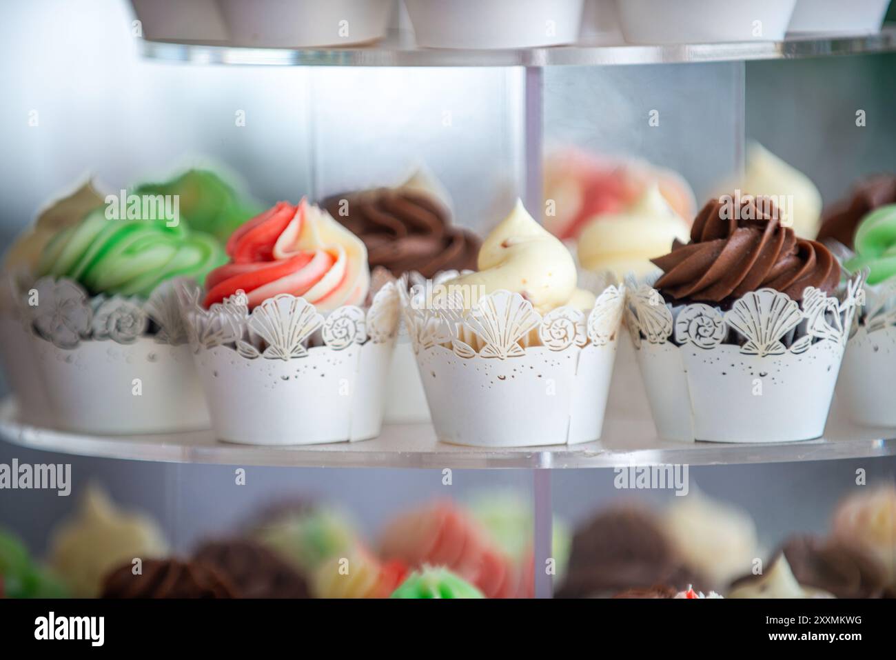 Flavorful Multi flavor and many cupcakes in fancy white lace cups ...