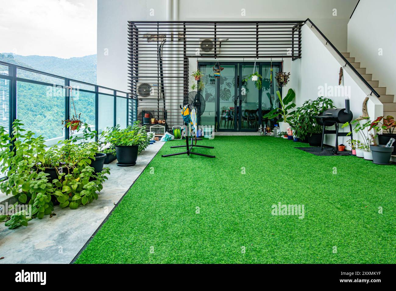 A large, spacious balcony with artificial grass belonging to a duplex ...