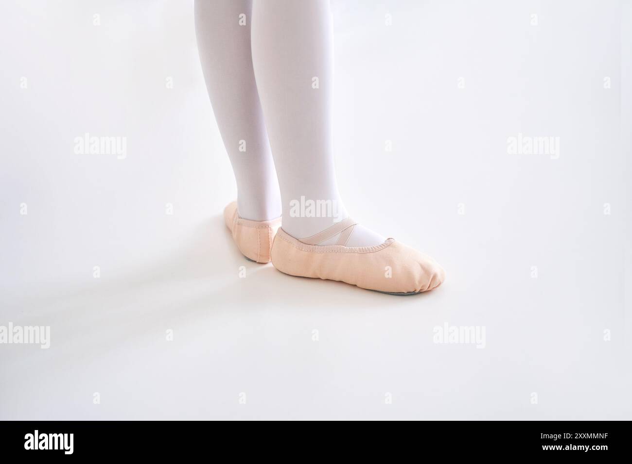 Young ballet girl at studio lesson. Training performance. Stretching ...