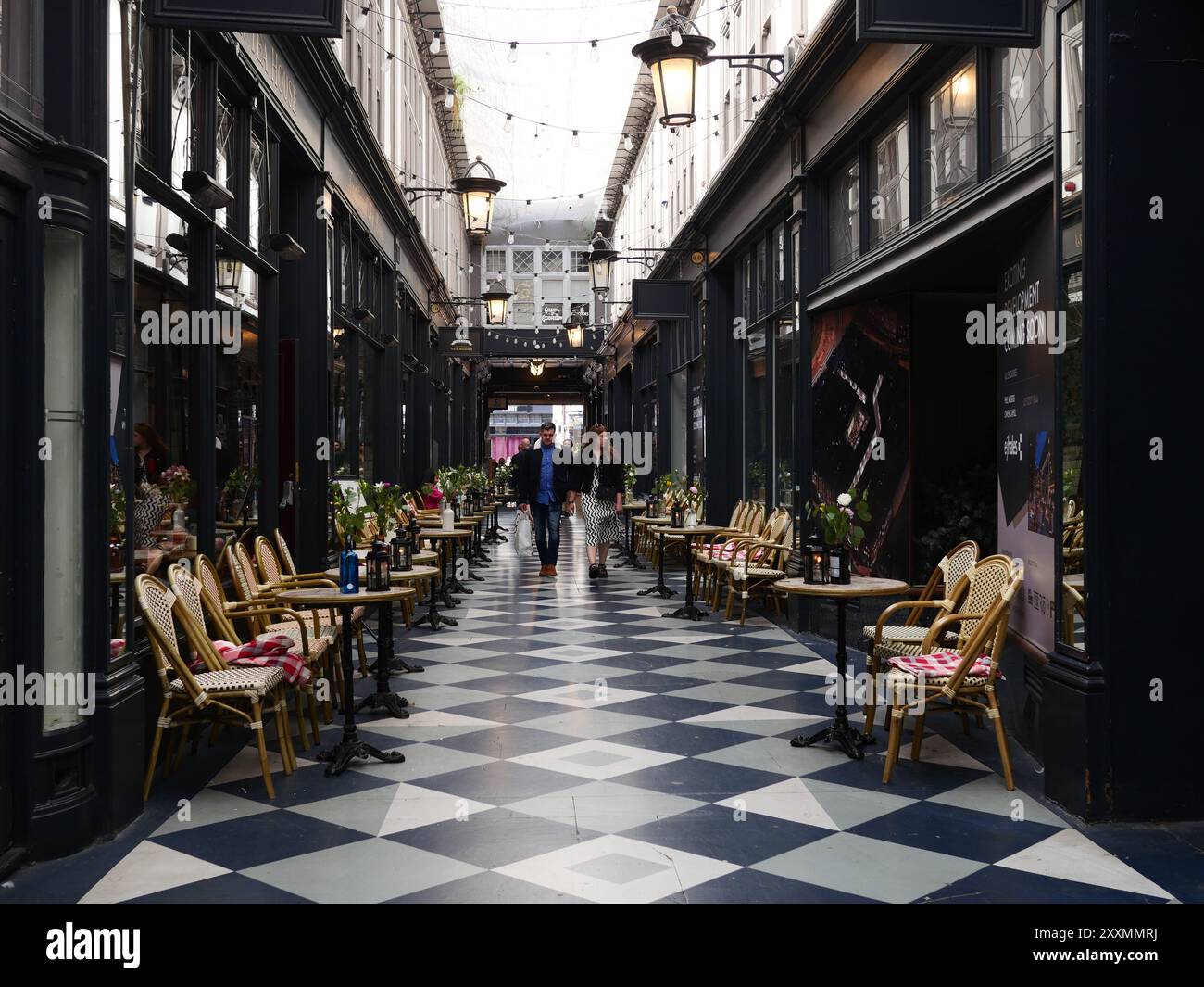 Cafe tables and seating in a Cardiff city centre arcade covered walkway ...