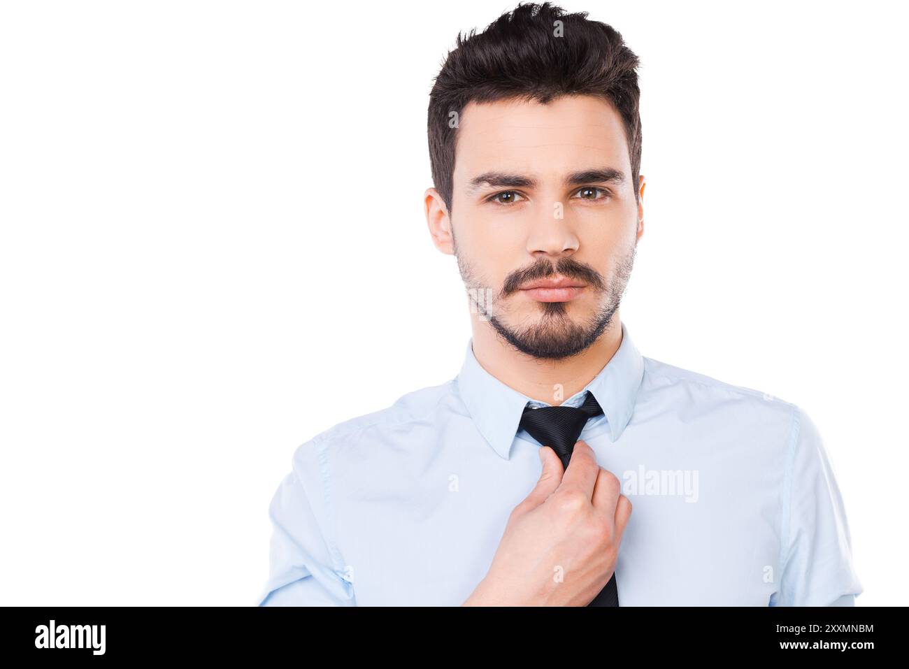 Confident and successful. Confident young man in shirt and tie looking ...