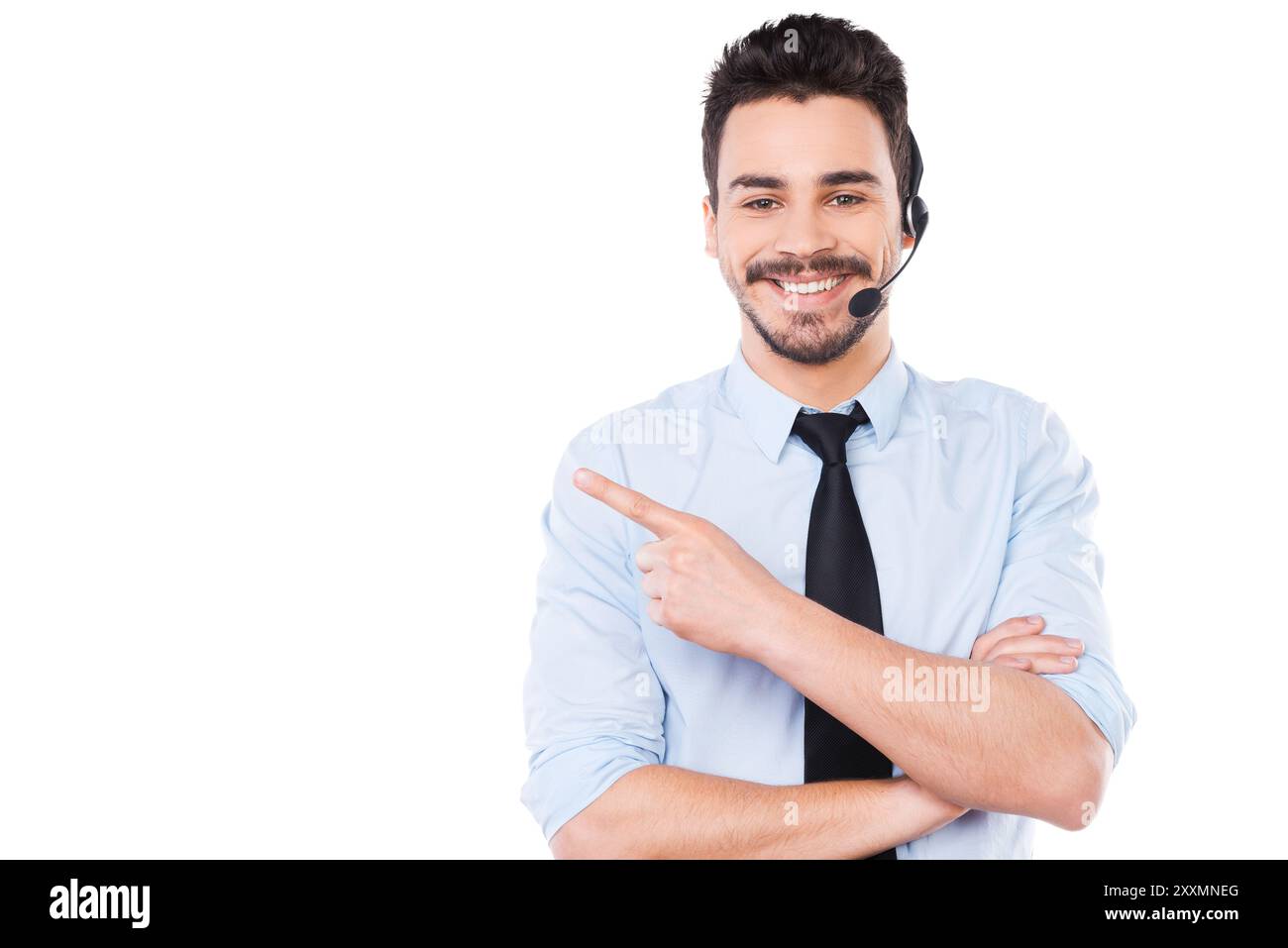 Advertising your product. Handsome young male operator pointing away ...