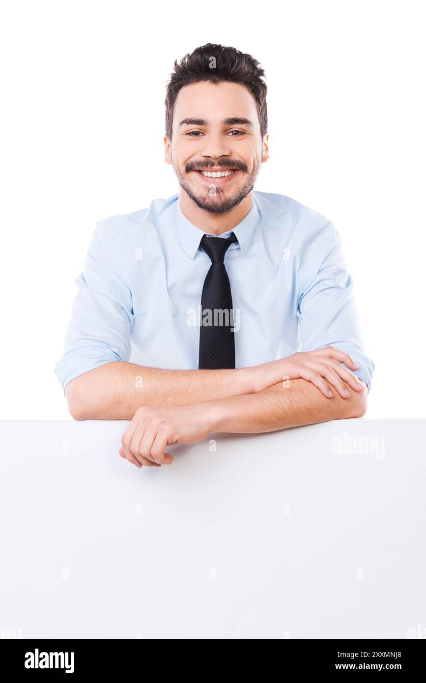 Confident business expert. Handsome young man in shirt and tie leaning ...