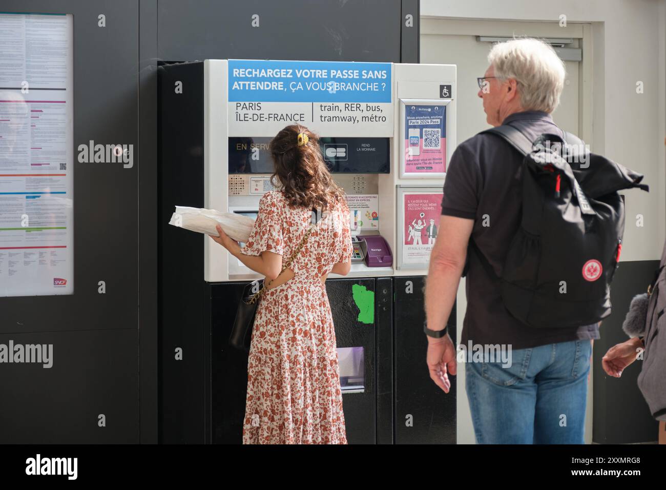 People buying train tickets using ticket machines in Pont Cardinet ...