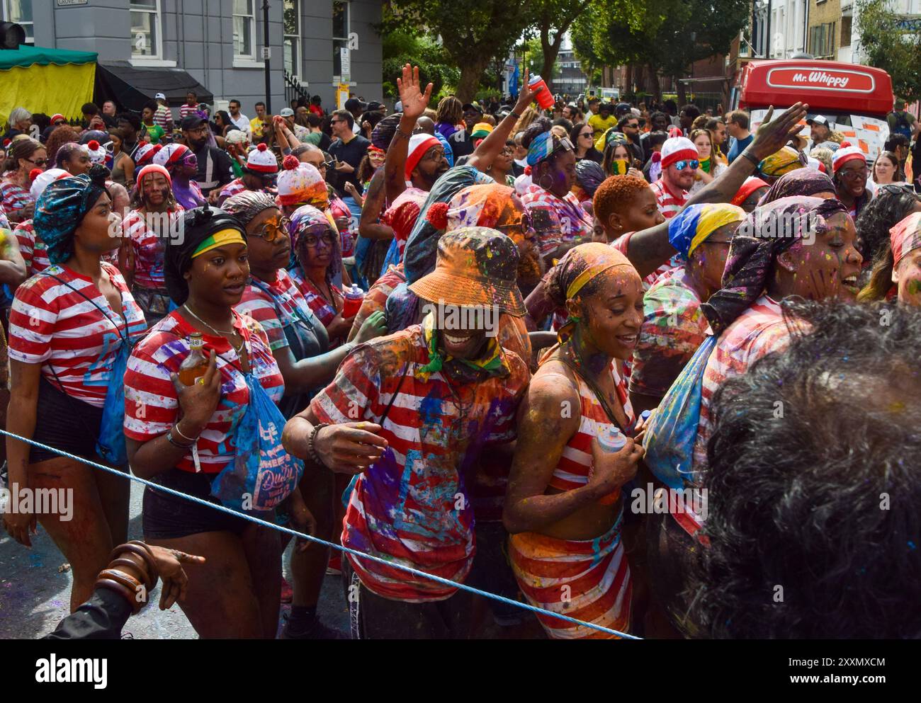 London, UK. 25th August 2024. Revellers dressed as children's puzzle ...