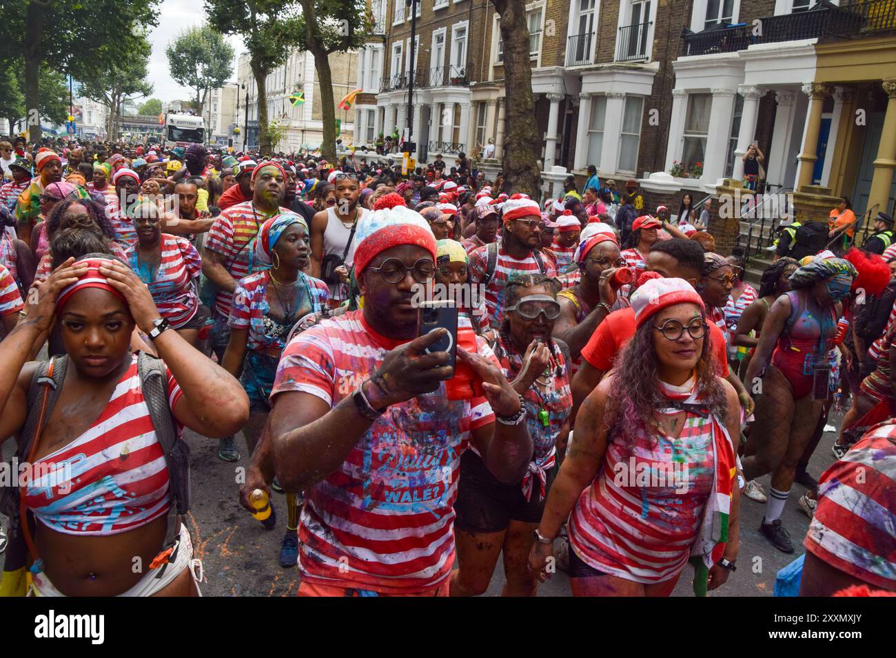 London, UK. 25th August 2024. Revellers dressed as children's puzzle ...
