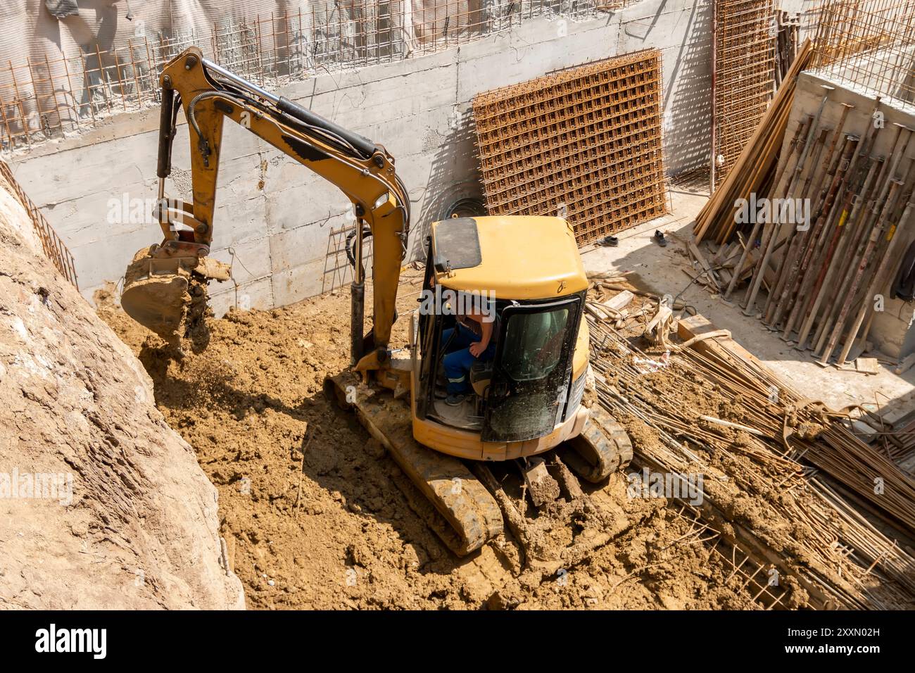 Construction excavator at work on construction site. Project in ...