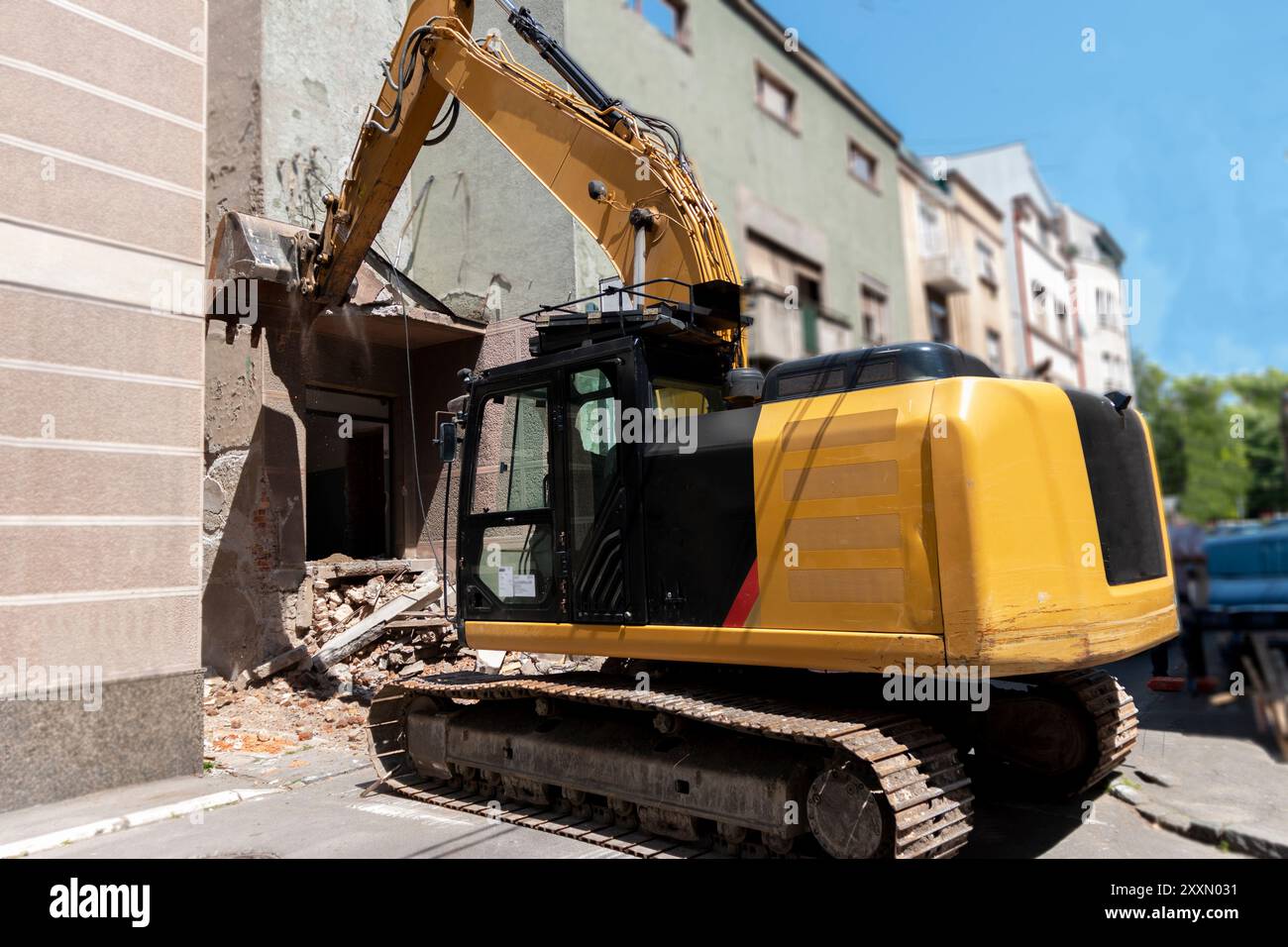 Process of demolition of old building dismantling. Excavator breaking ...
