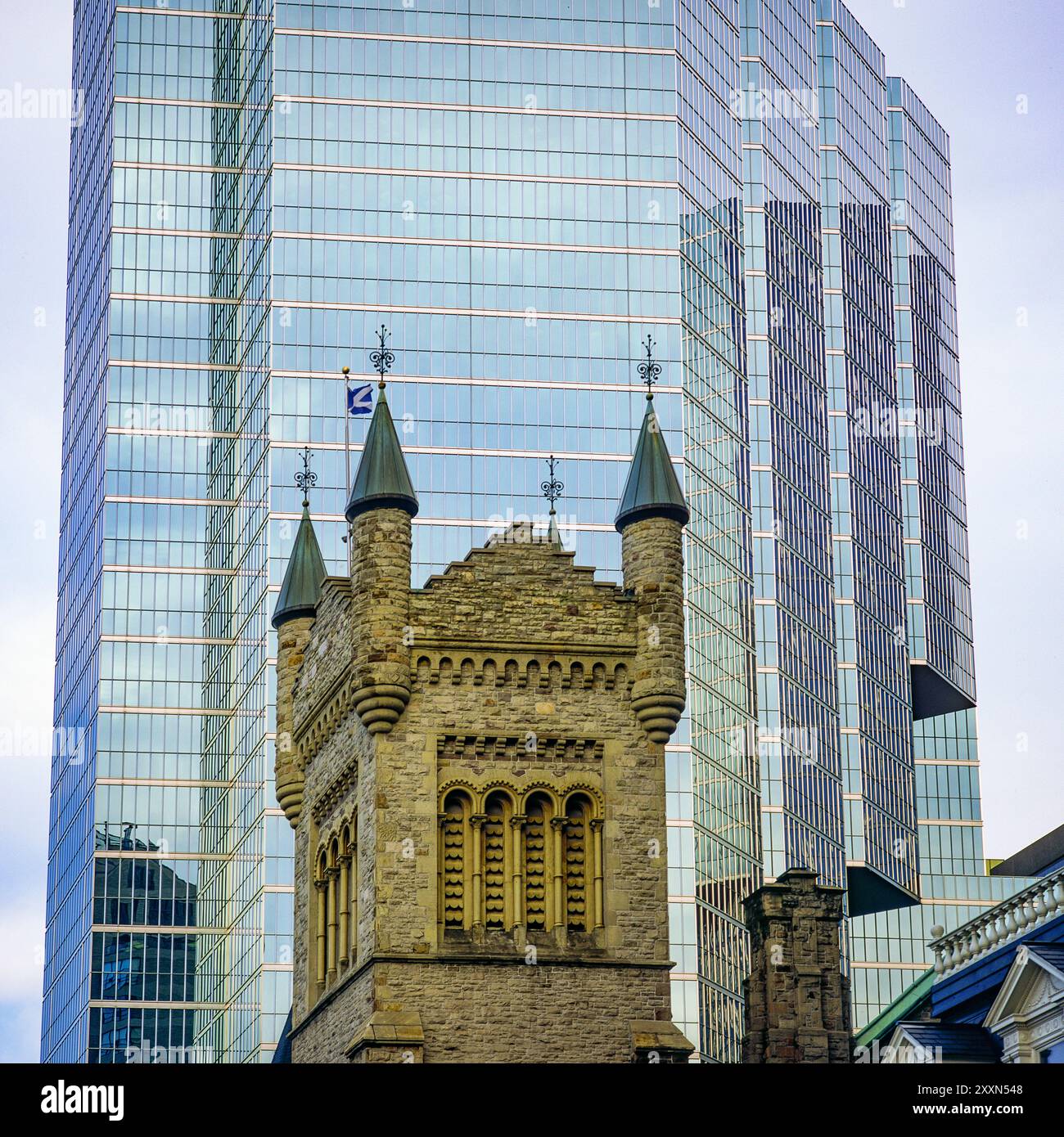 St Andrew's Presbyterian church tower in front of a modern glass high ...