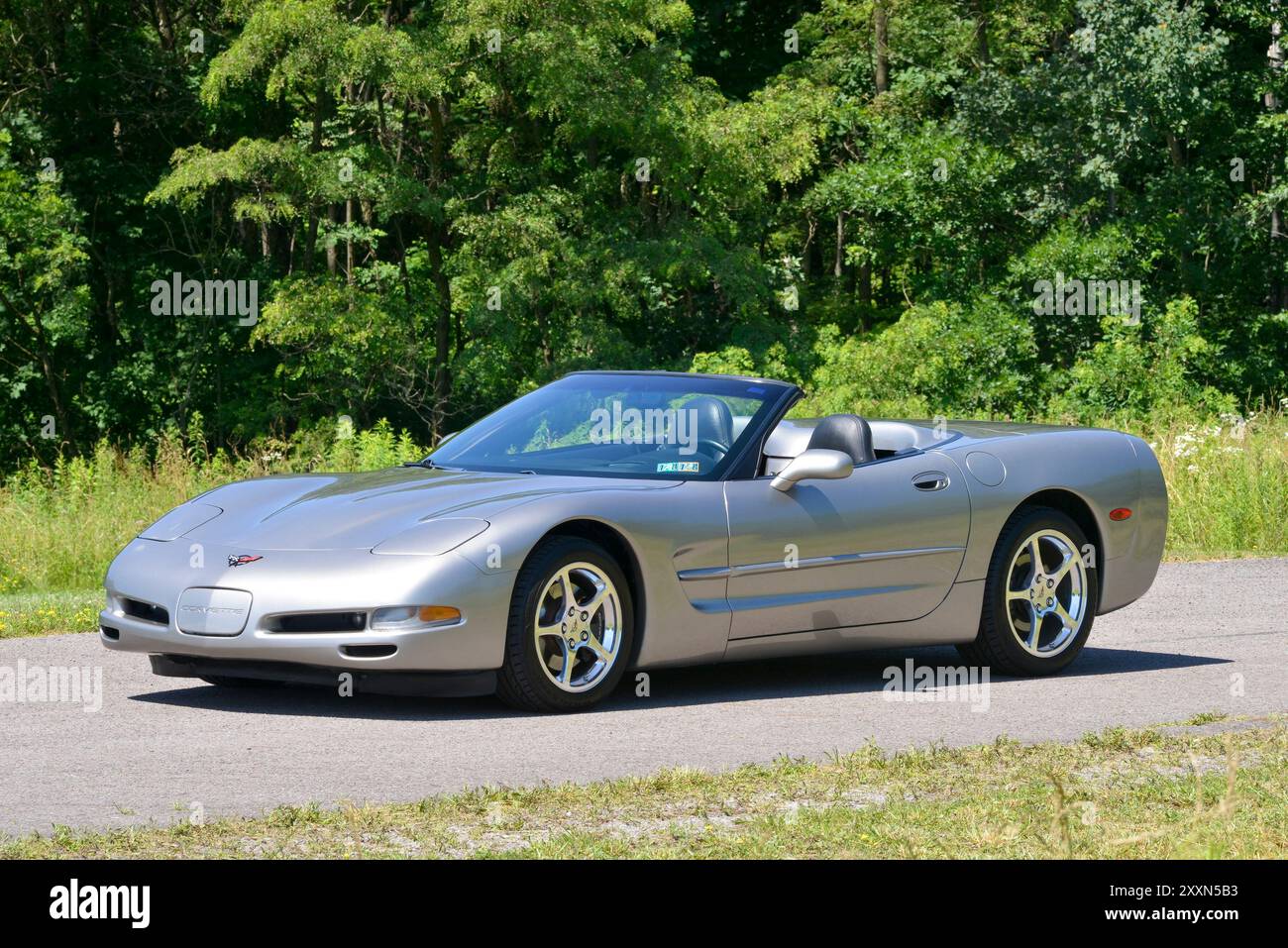 A light pewter 2000 Corvette convertible with its top down is parked ...