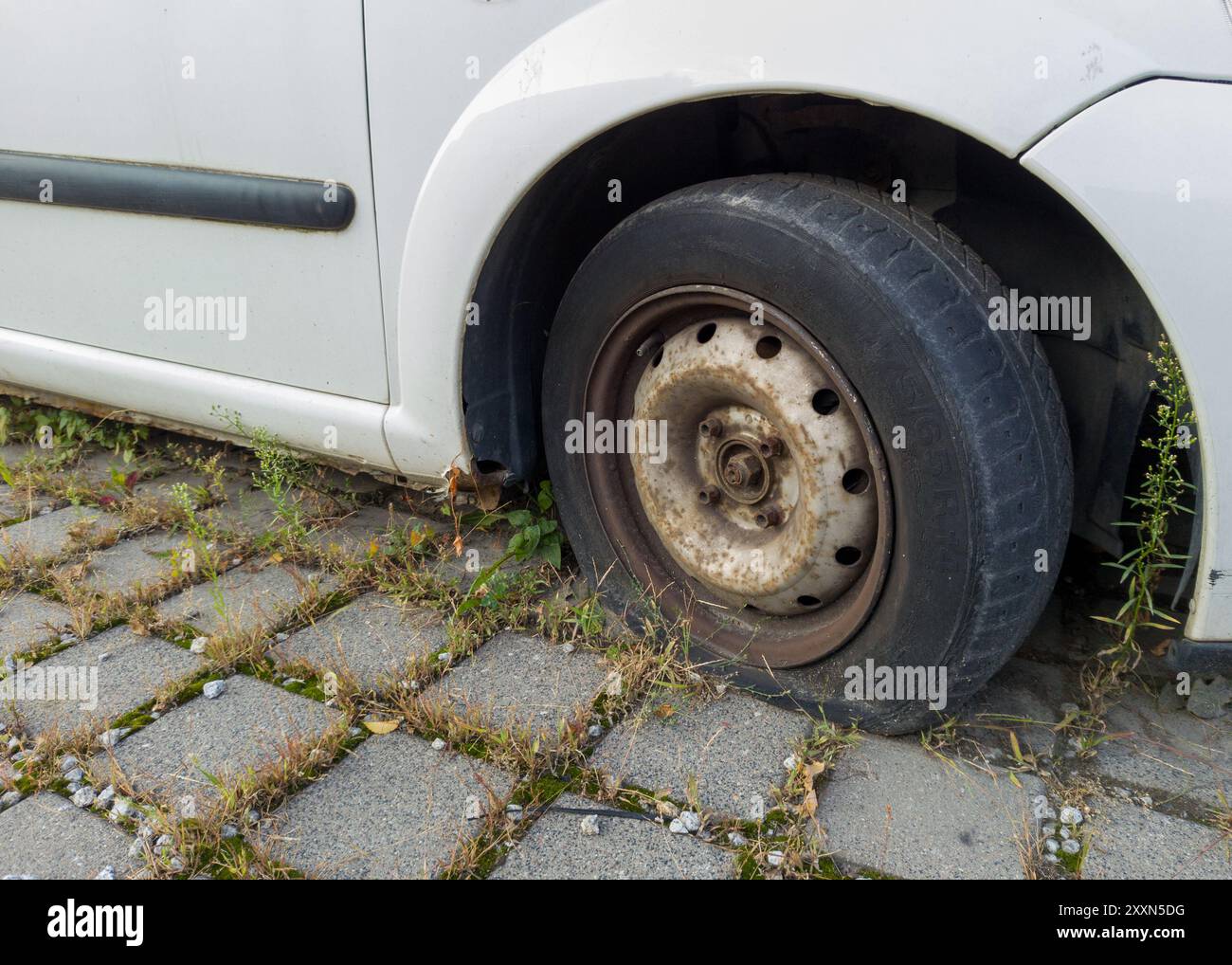 Rusty Car Wheel with Flat Tire on Pavement Stock Photo - Alamy