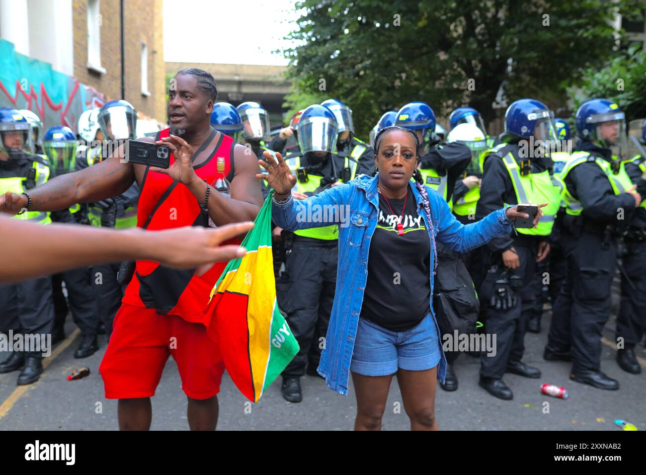 London, UK, 25 Aug 2024. Black Women And Man Stand Between Police And ...