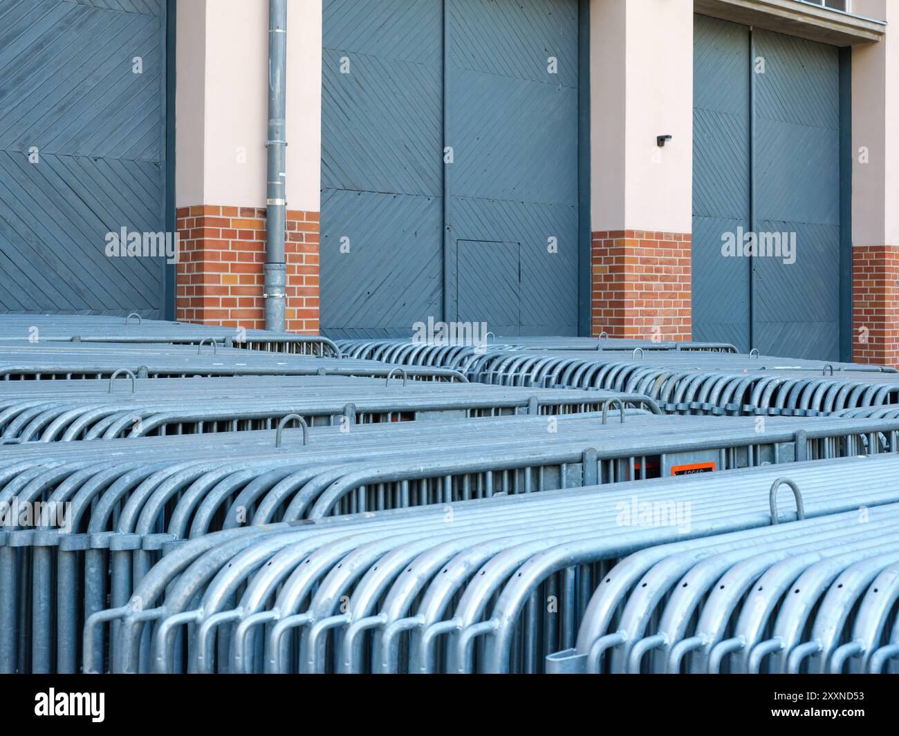 Stored police crowd control barriers made of steel stacked in front of ...