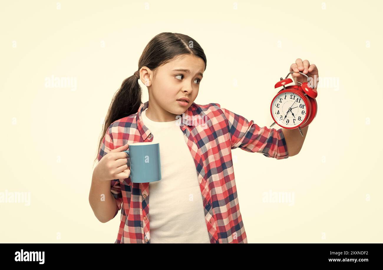 confused girl with morning coffee and alarm on background. photo of ...