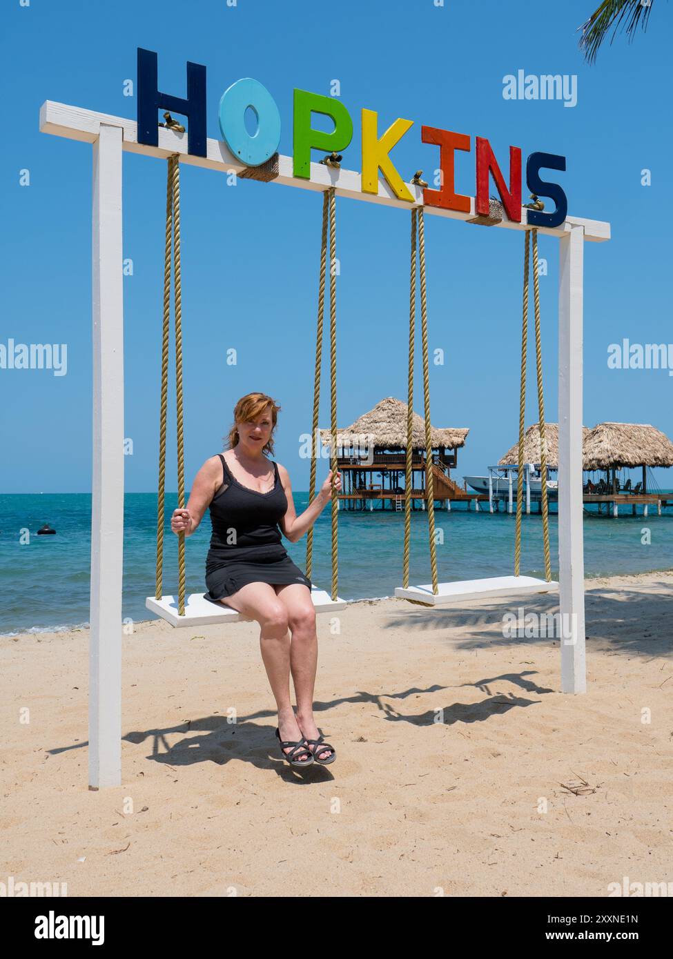 Woman on Beach Sitting on Swing, Hopkins, Belize Stock Photo - Alamy