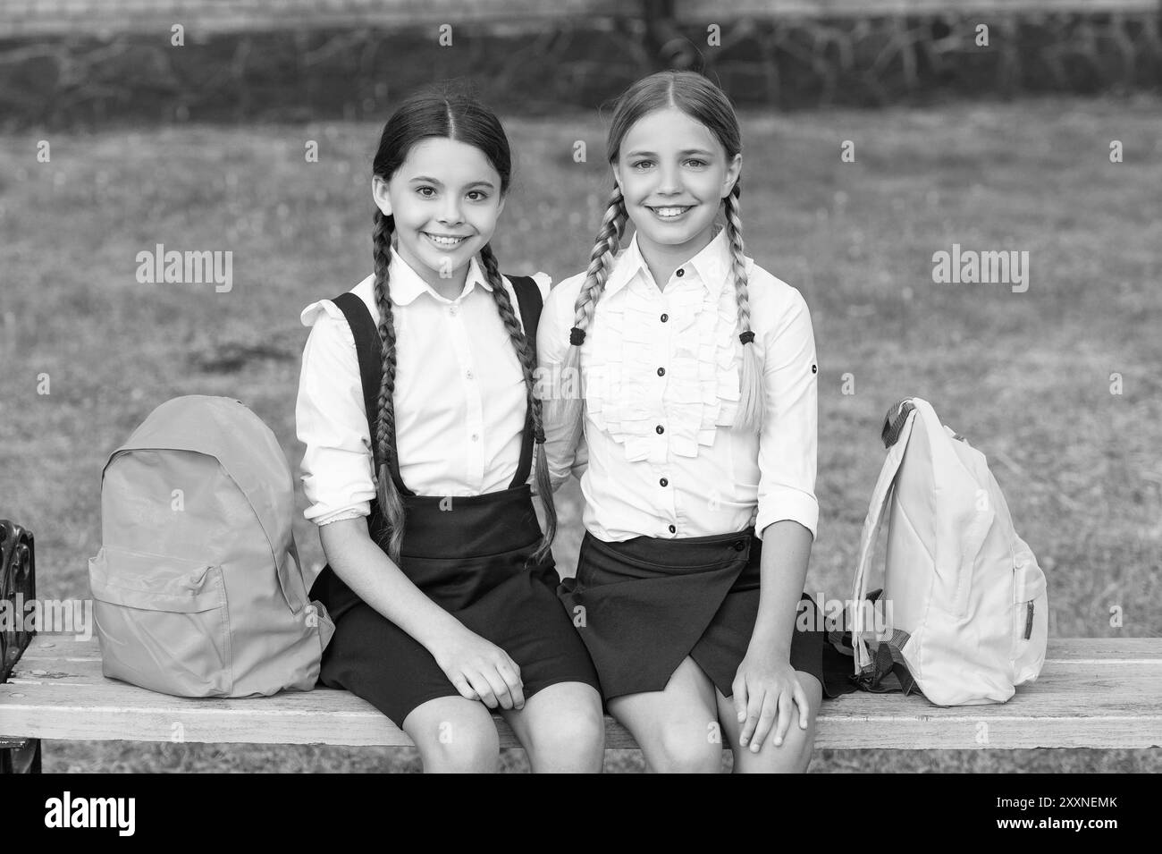 back to school. two glad teen children after school outdoor. friendship ...