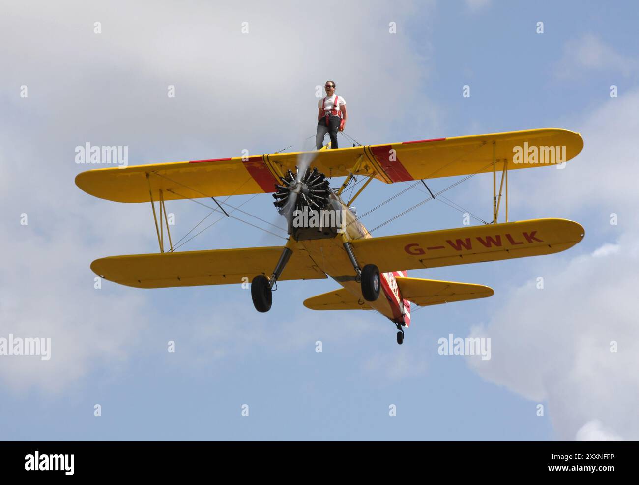 An wing walker enjoys a ride on a Boeing A-75L300 Stearman of the Wing ...