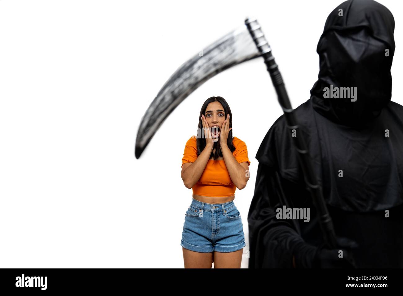 terrified young woman faces the grim reaper, who is dressed in a ...