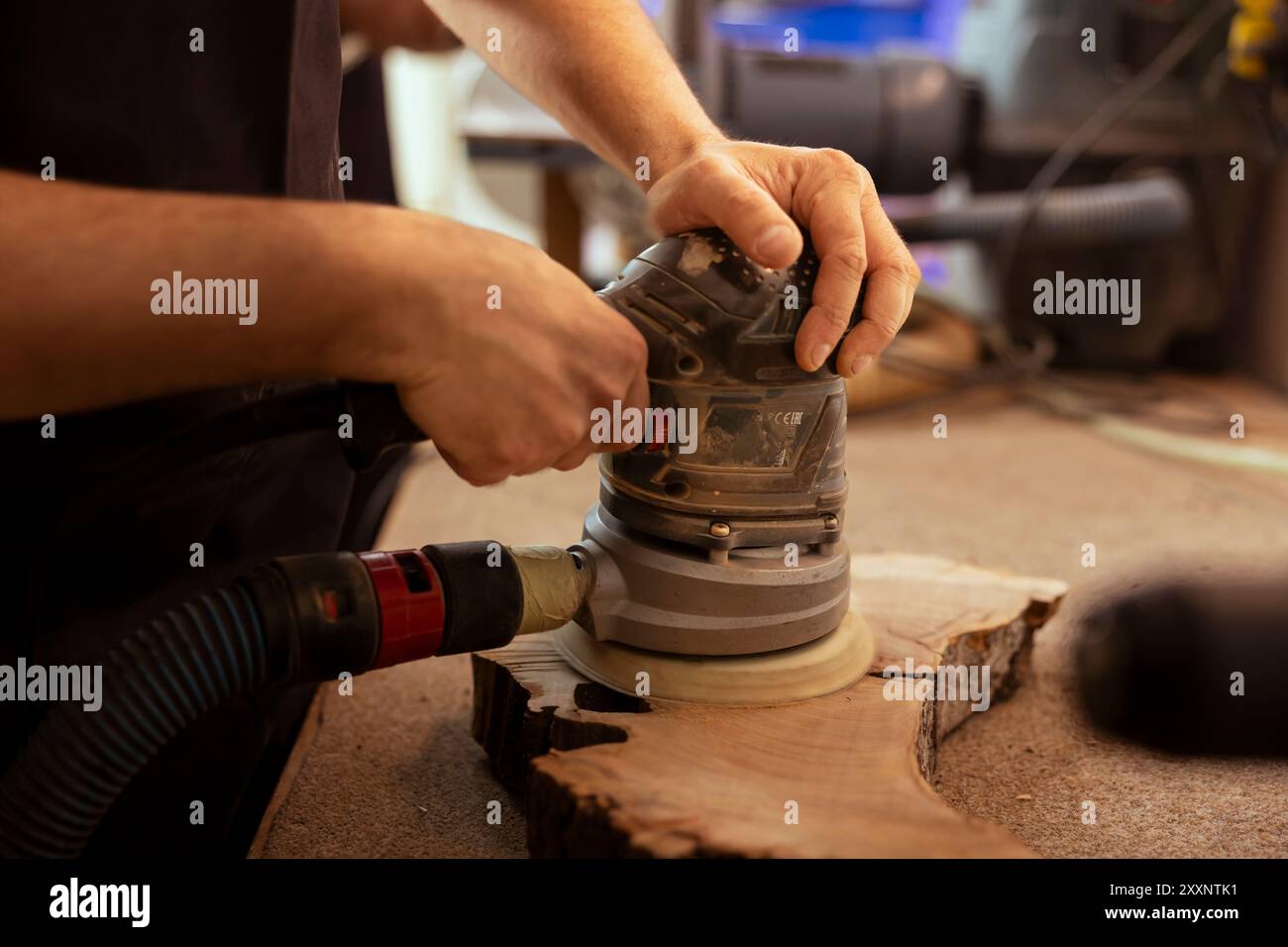 Artisan in studio enjoying diy hobby, using orbital sander with fine ...