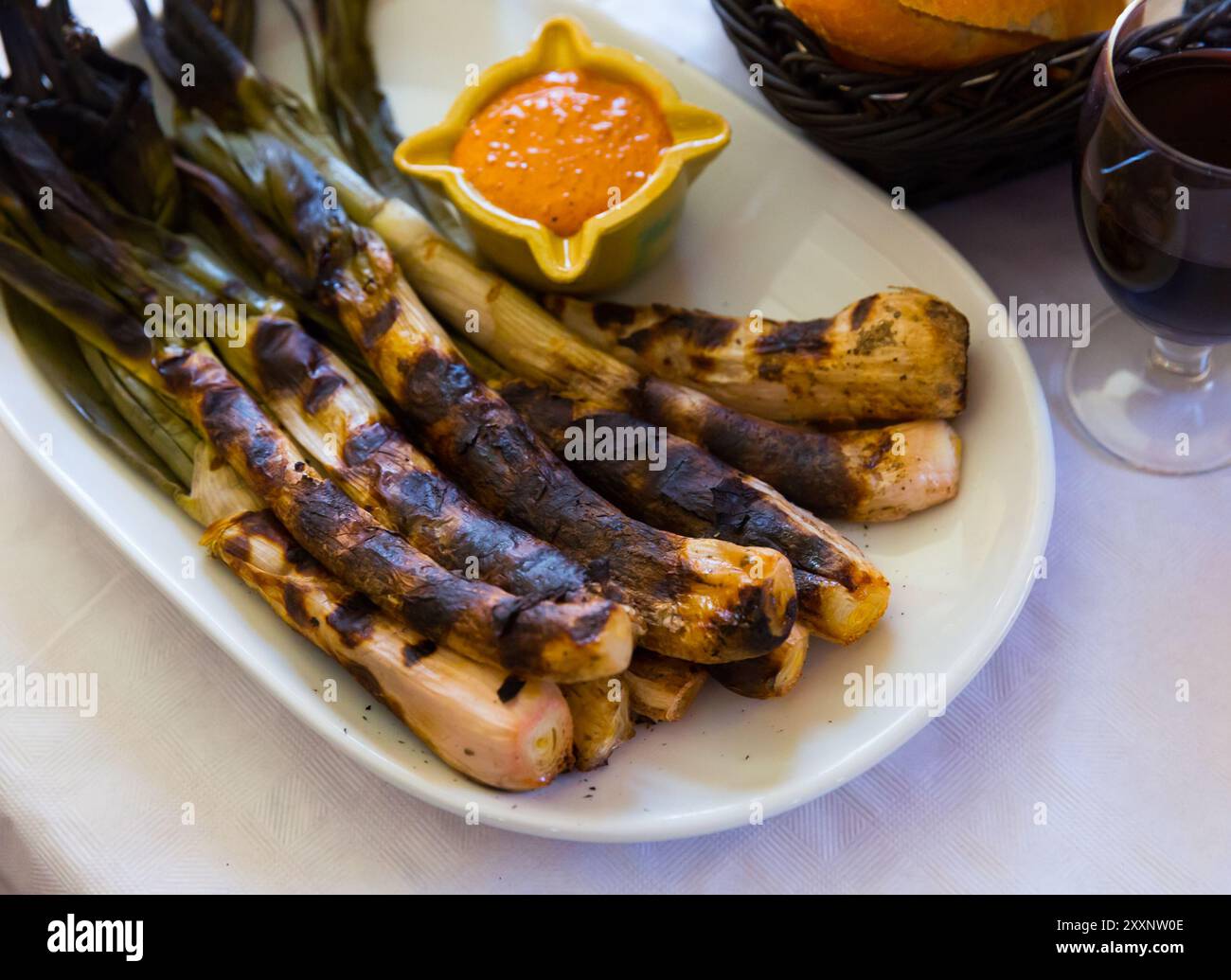Roasted calcots with romesco sauce Stock Photo - Alamy