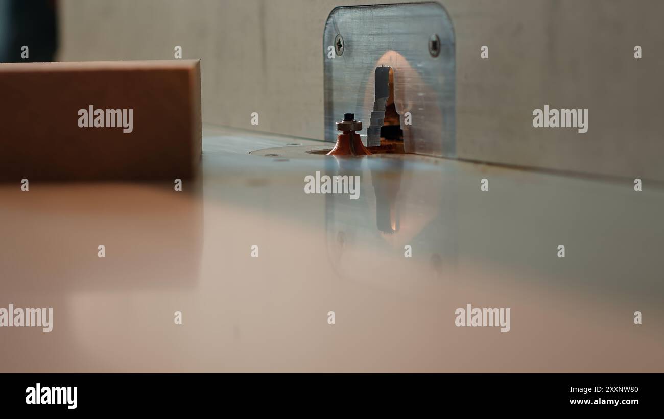 Man putting lumber block through spindle moulder, creating smooth edges ...