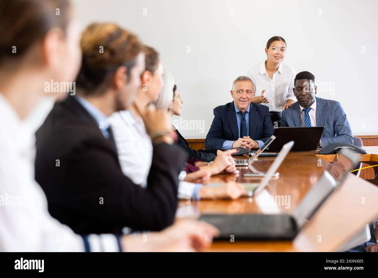Executive team holding corporate meeting at office with assistance ...