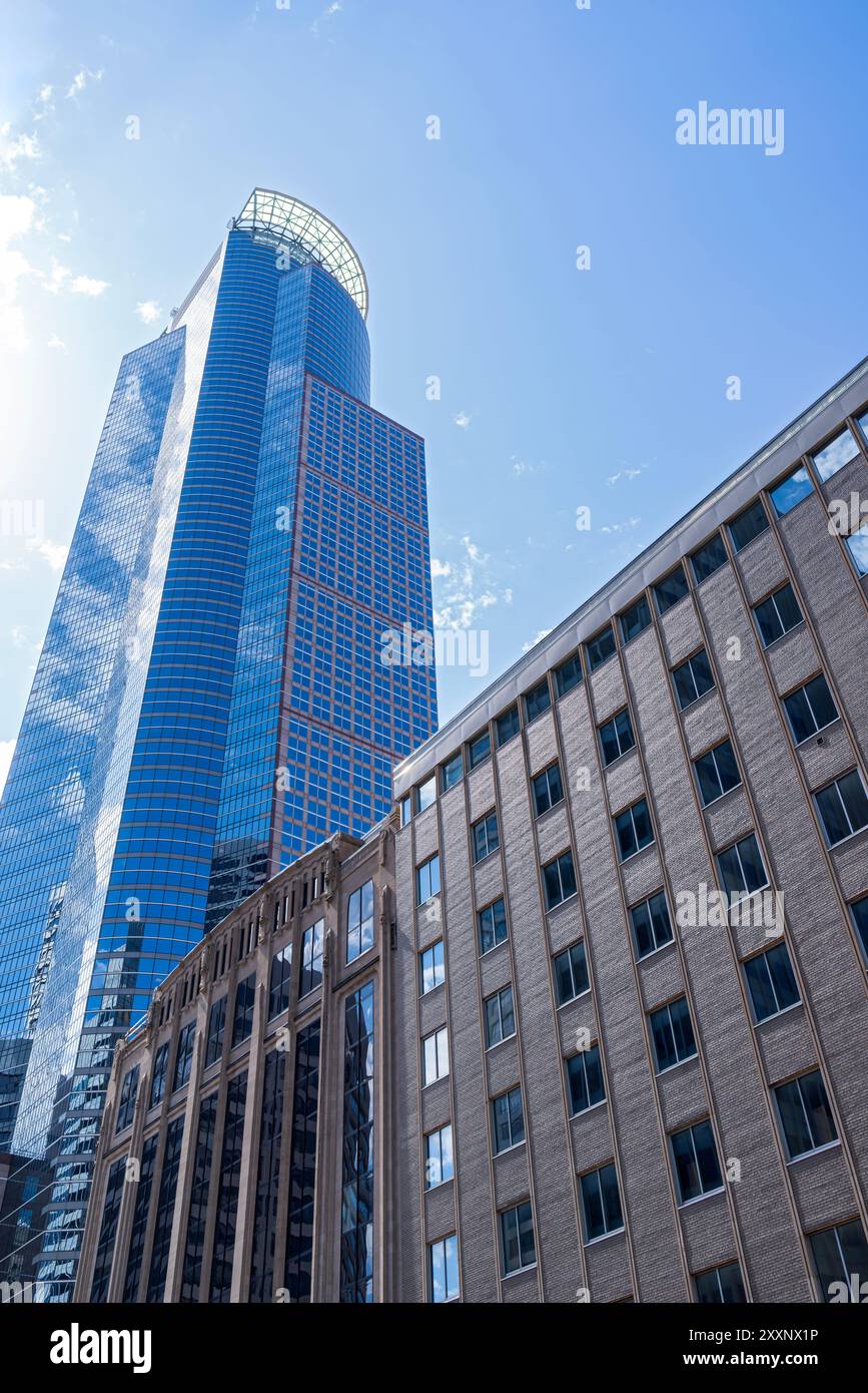 modern architecture of glass office tower rising above historic multi ...