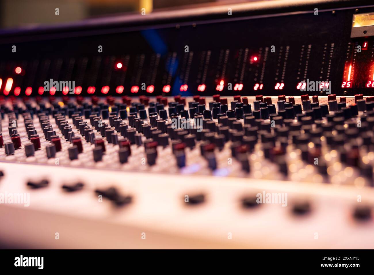 Mixing console and music production knobs in empty control room ...